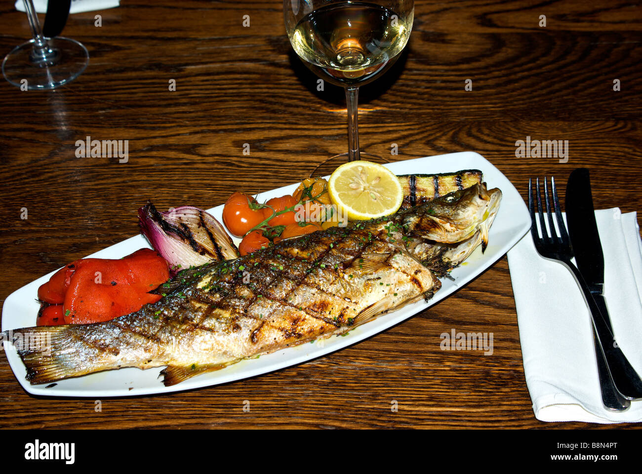 Whole bream grilled entree with chives sweet red peppers cherry ...