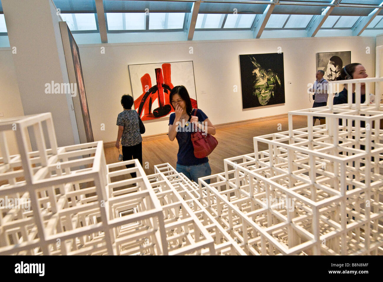 Visitors viewing an exhibition of paintings and sculptures at the ...