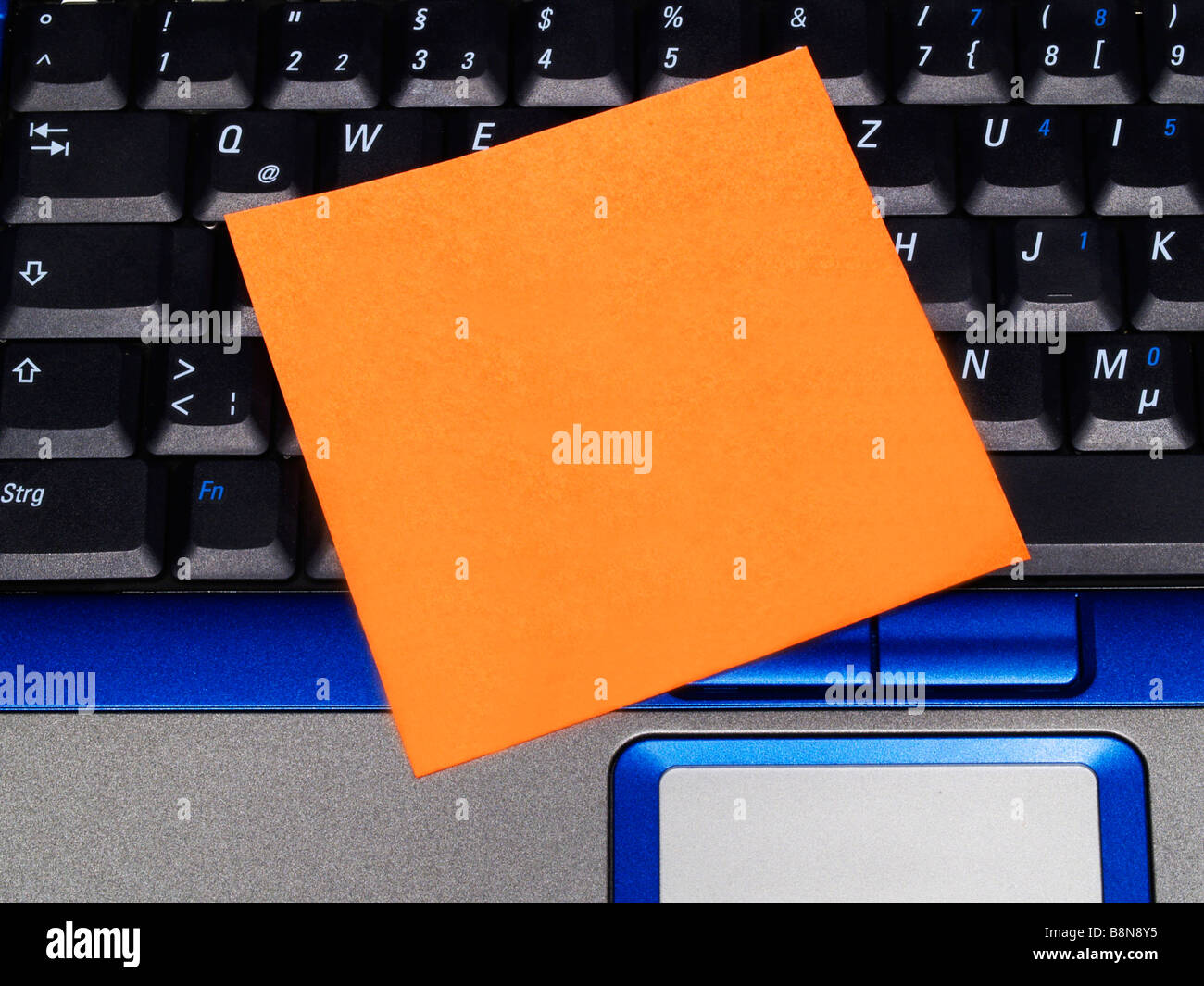 memo note on notebook, empty, orange Stock Photo - Alamy