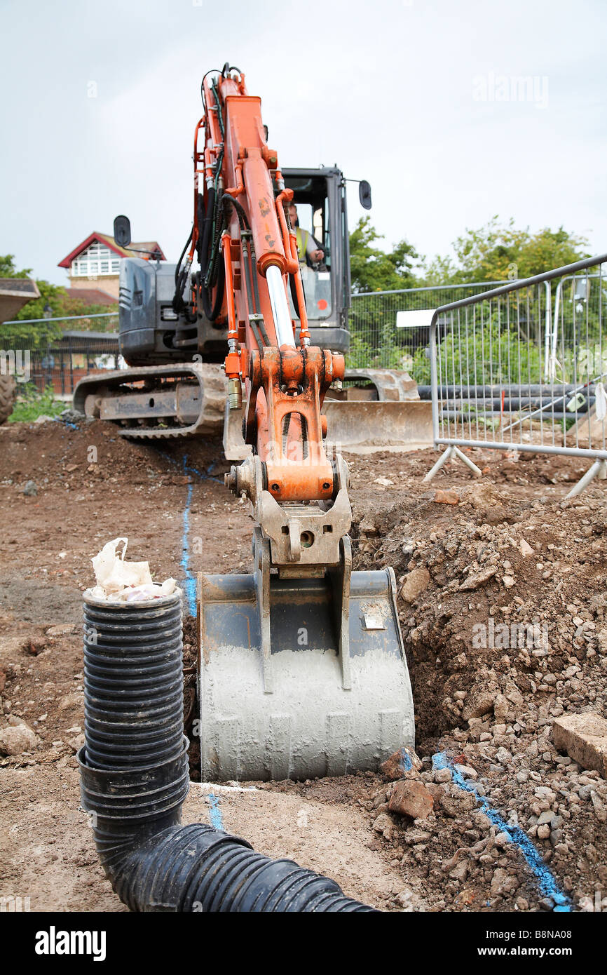 Jcb digging a trench on a construction site Stock Photo - Alamy