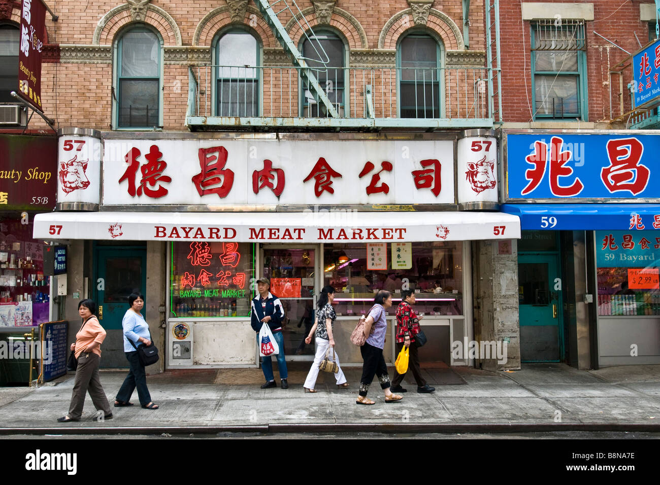 Pedestrians walking along the sidewalk in Chinese neighbourhood of ...