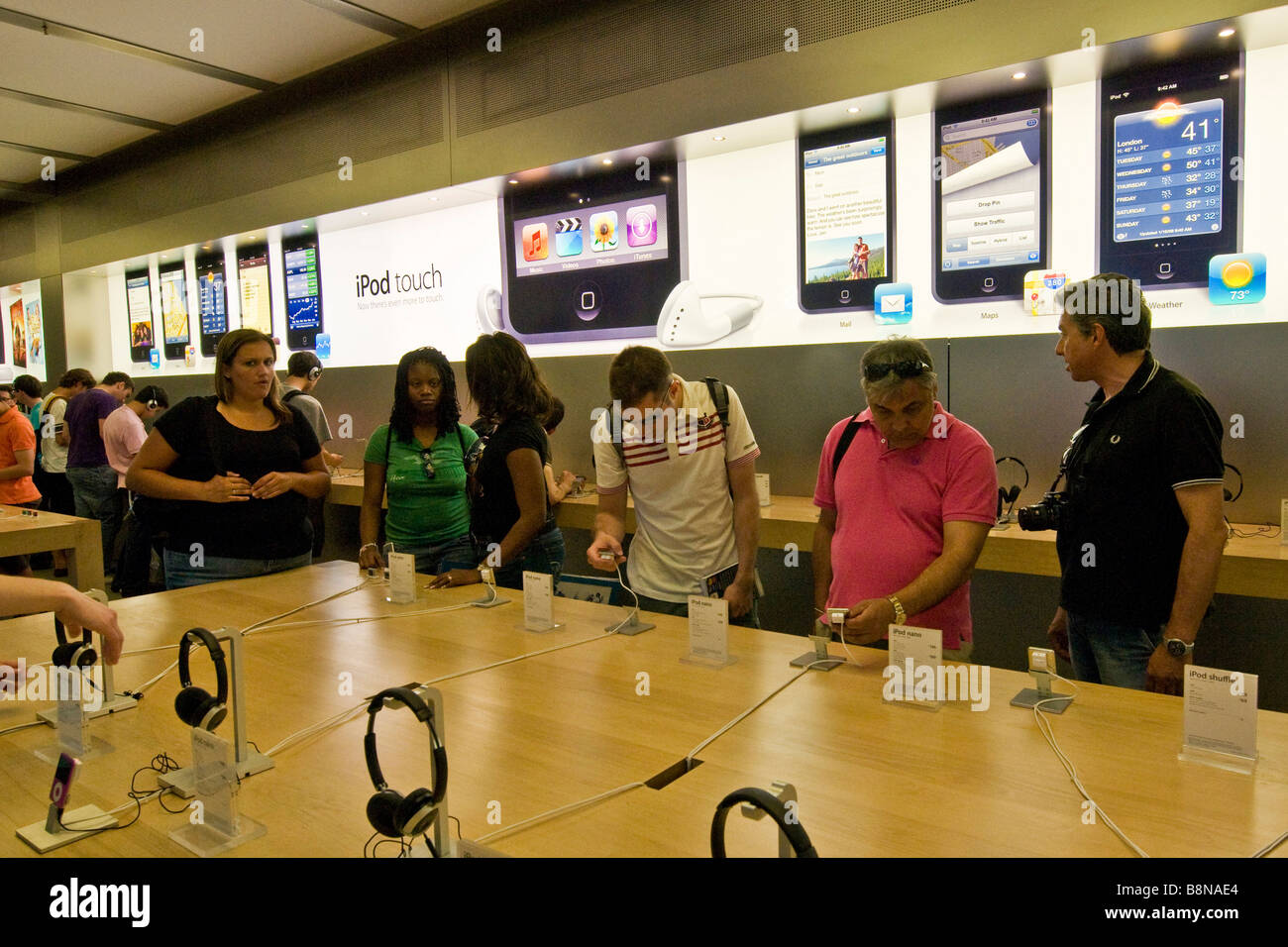 Shoppers testing Apple IPhone inside the Apple Mac store on 5th avenue ...