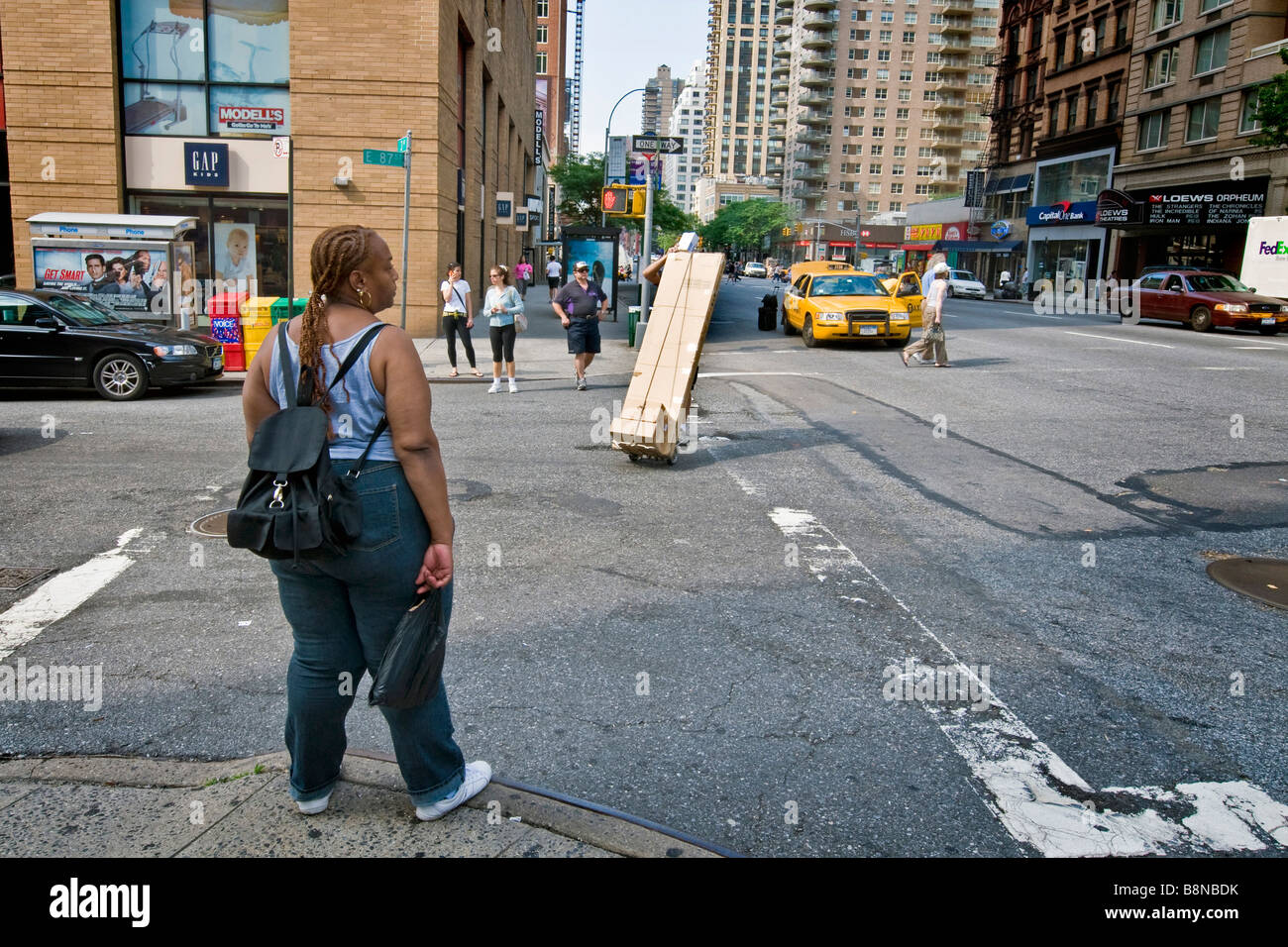93rd St street scene with taxis, joggers and pedestrians Stock Photo ...
