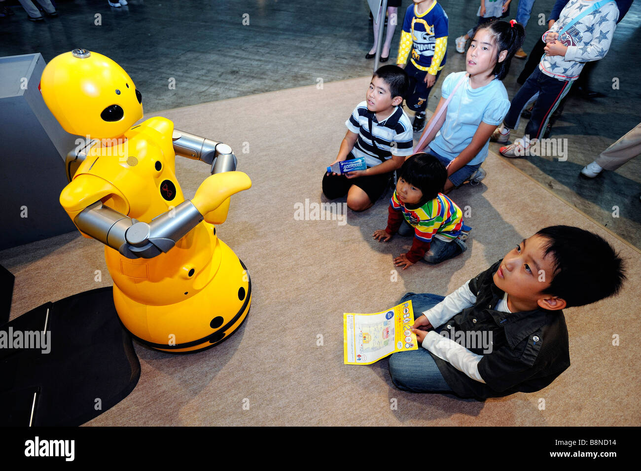 Japanese children watch a humanoid robot perform Stock Photo - Alamy