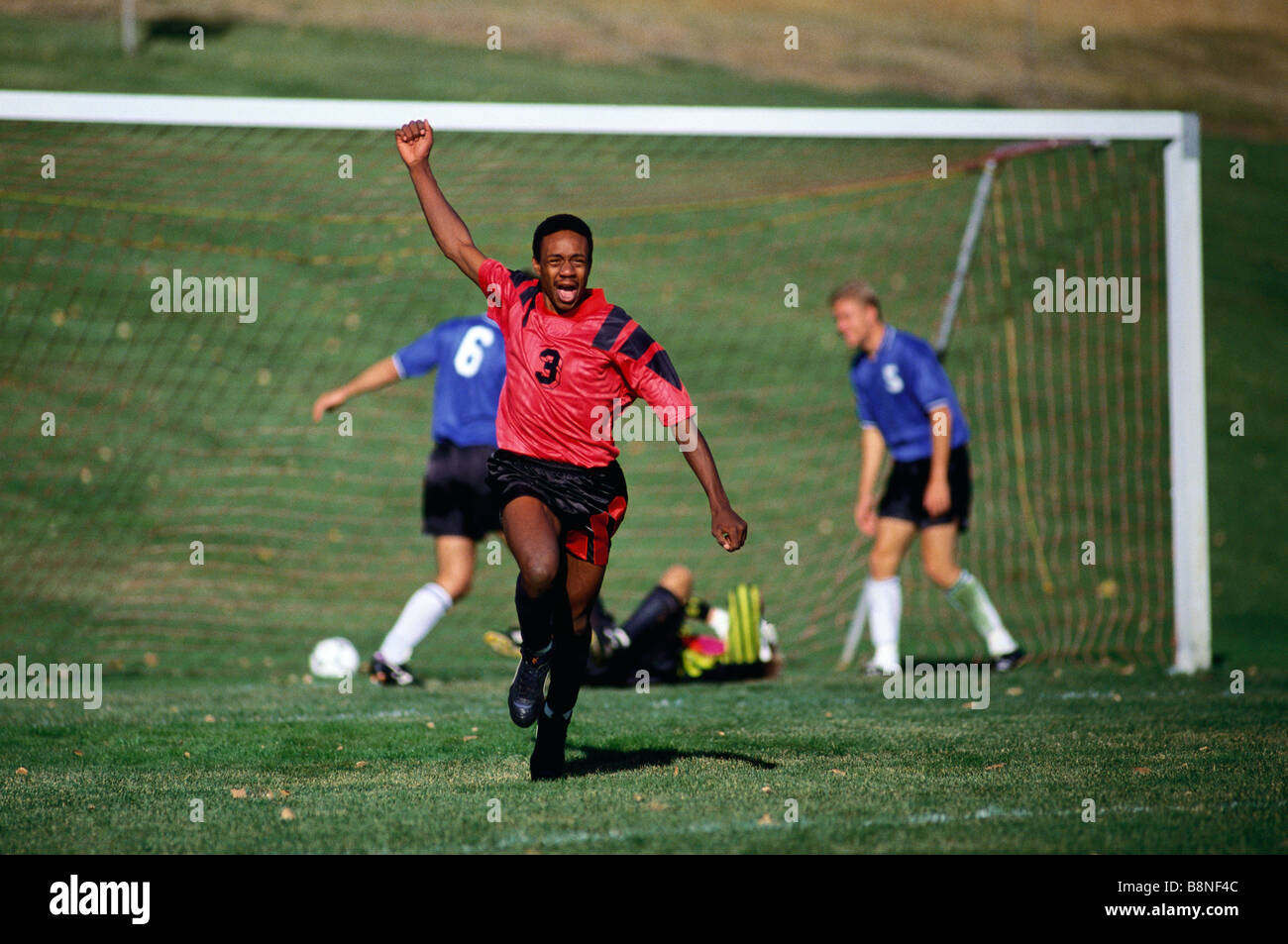 Soccer player celebrating after scoring a goal Stock Photo - Alamy