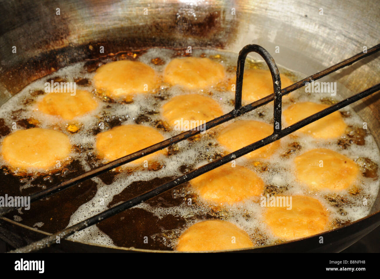 China Xian Shaanxi Traditional Hui Muslim cakes being fried in oil ...