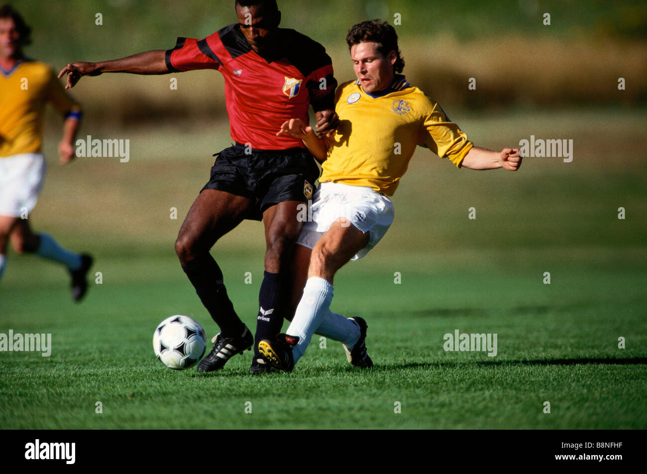 Soccer players fighting for the ball Stock Photo - Alamy