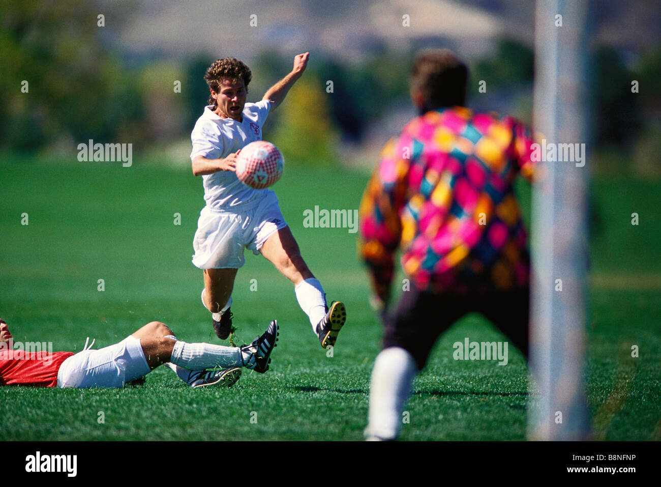 Soccer playersshooting on goal Stock Photo - Alamy