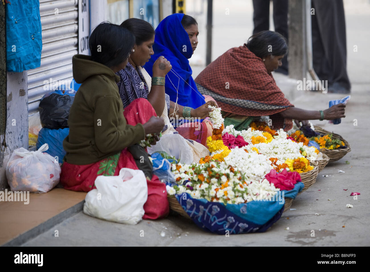 Women selling flowers on the street in India Stock Photo - Alamy