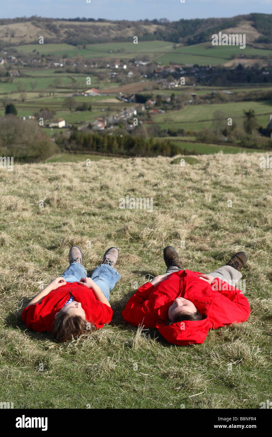 Two female hill walkers ramblers resting in Spring sunshine on top of ...