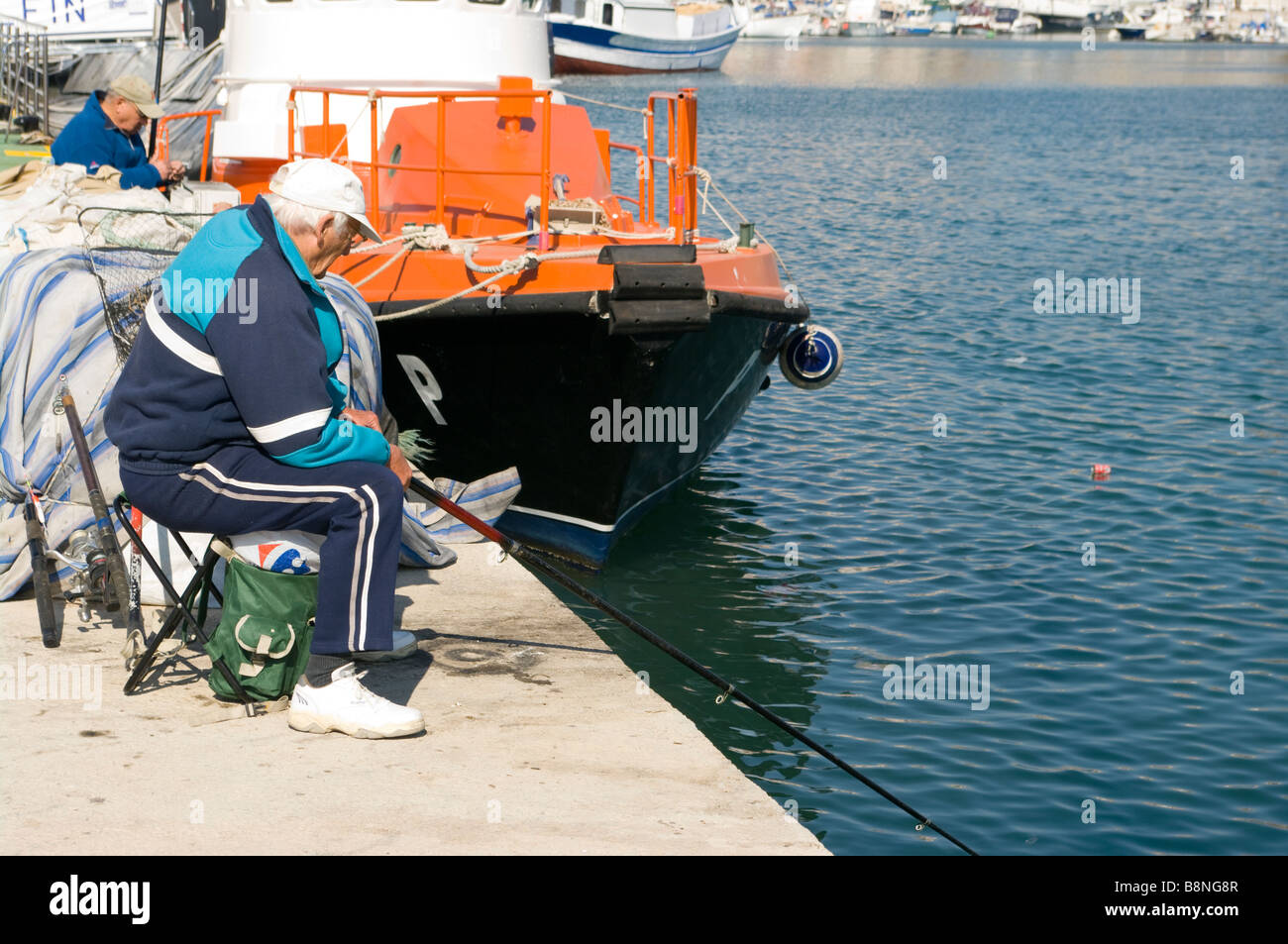 Spanish Elderly Man Angler Angling fishing On The Quayside Torrevieja ...