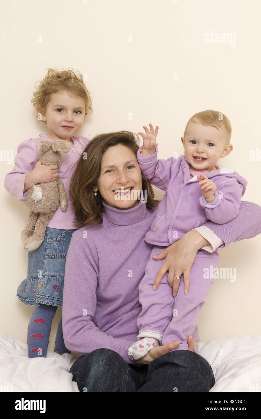 Mum and daughters in Lilac Stock Photo - Alamy