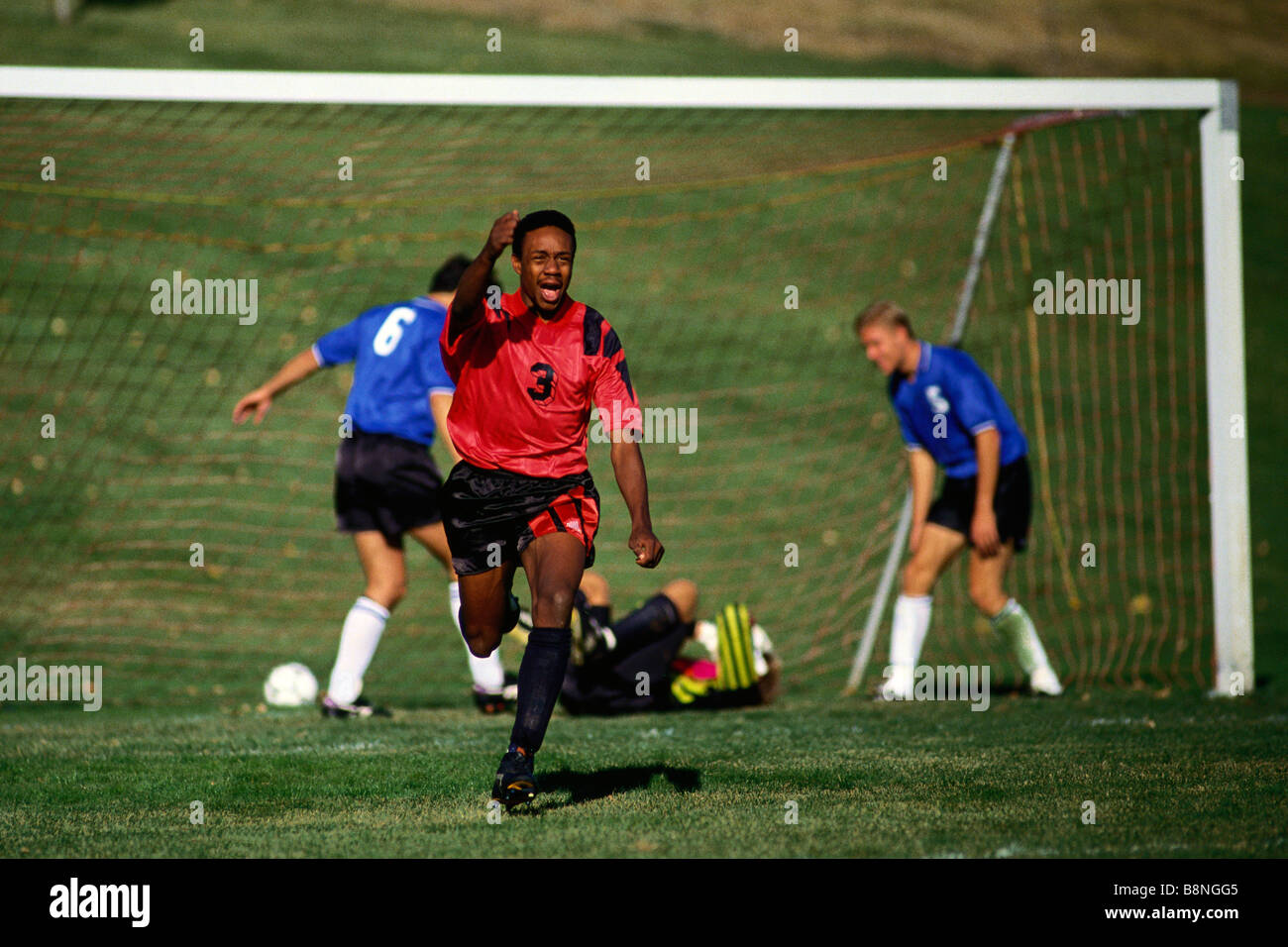 Soccer player celebrating after scoring a goal Stock Photo - Alamy