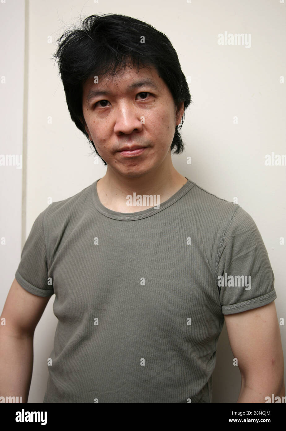 Chinese man looking fed up Stock Photo - Alamy