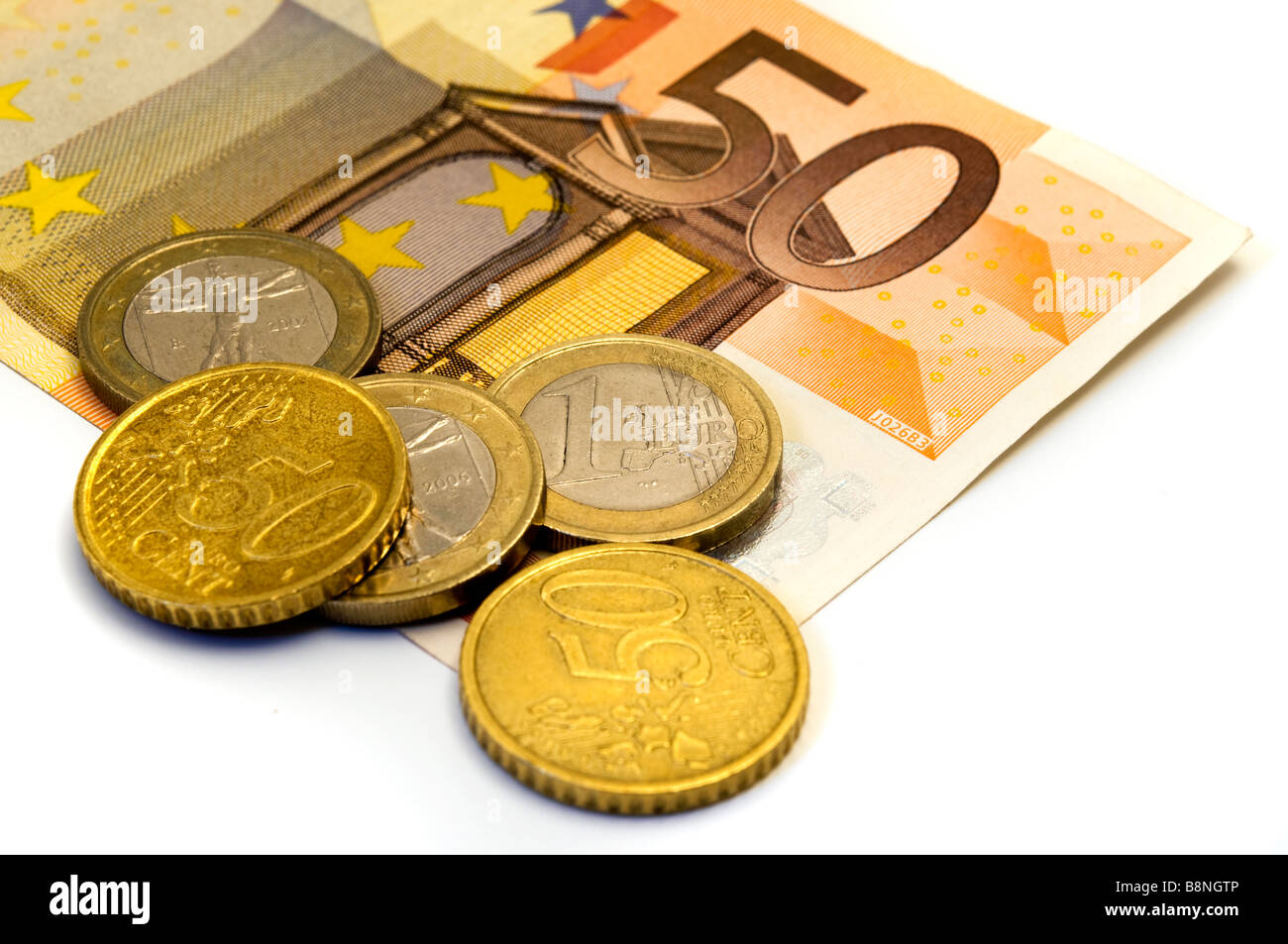 Coins and banknotes on a white background Stock Photo - Alamy