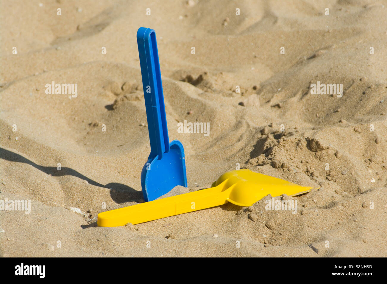 Blue and Yellow Plastic Childrens Sand Spades Beach Toys Stock Photo ...