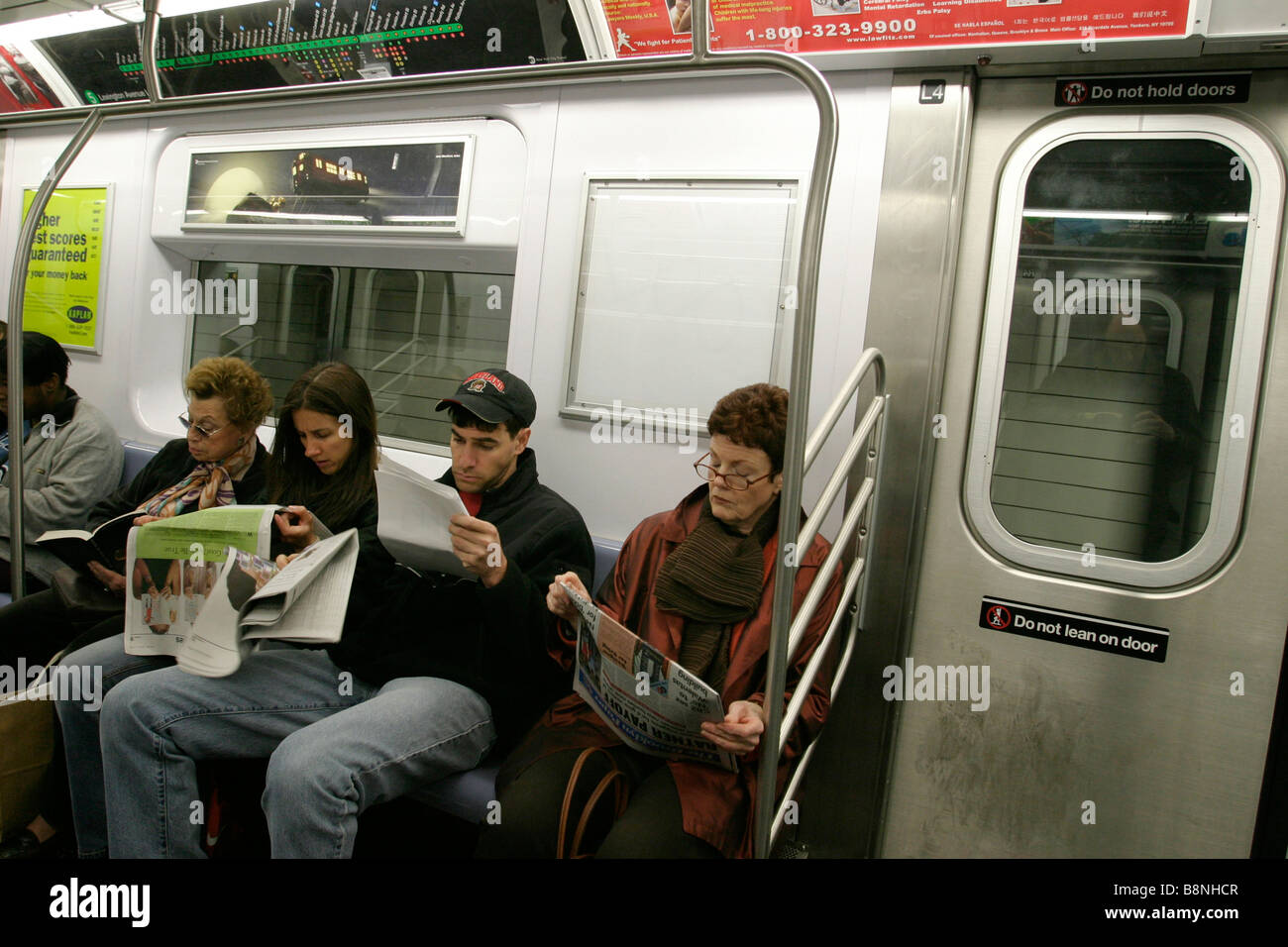 Passengers reading on the New York City subway Stock Photo - Alamy