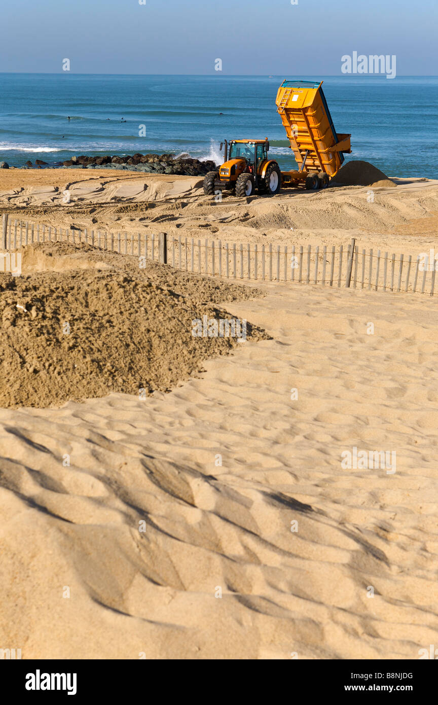 Tractor moving sand on Anglet beach France Stock Photo - Alamy