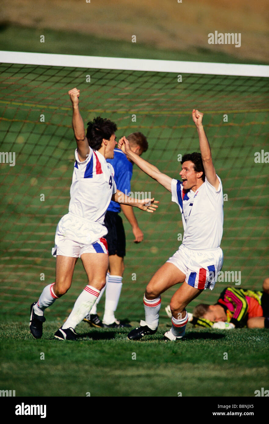 Soccer players celebrating after scoring a goal Stock Photo - Alamy