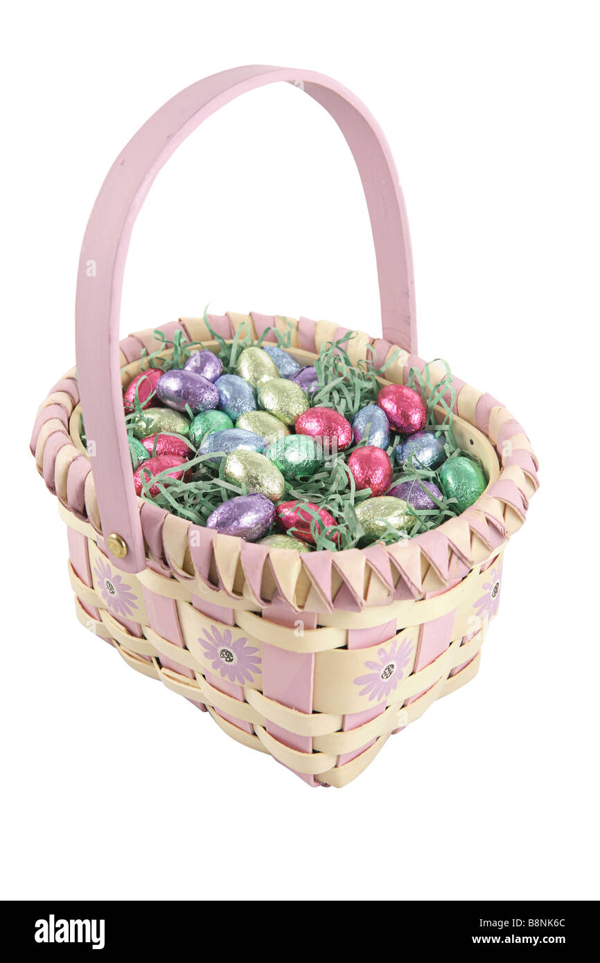 A pretty easter basket filled with chocolate candy eggs Isolated with ...