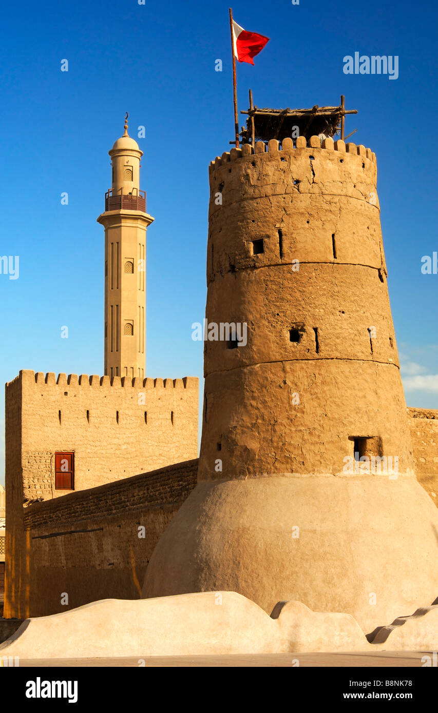 Tower of the Al Fahidi Fort, of the Grand Mosque behind, Dubai, United ...