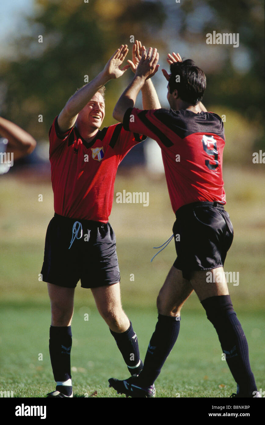 Soccer players celebrating after scoring a goal Stock Photo - Alamy