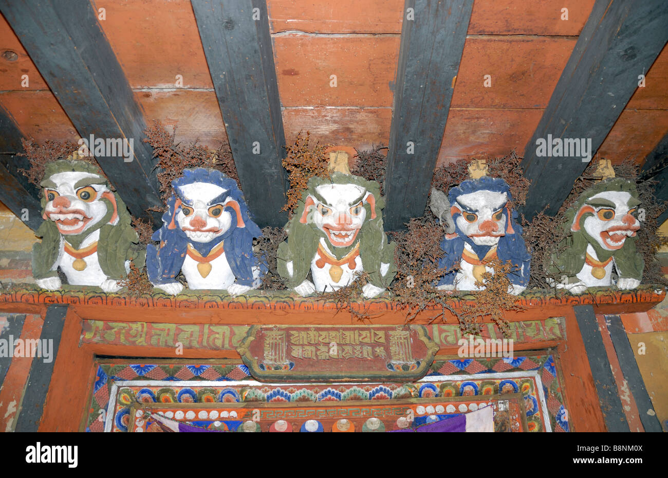A row of five snow lions sit above a door. Tamshing Goemba, Bumthang ...