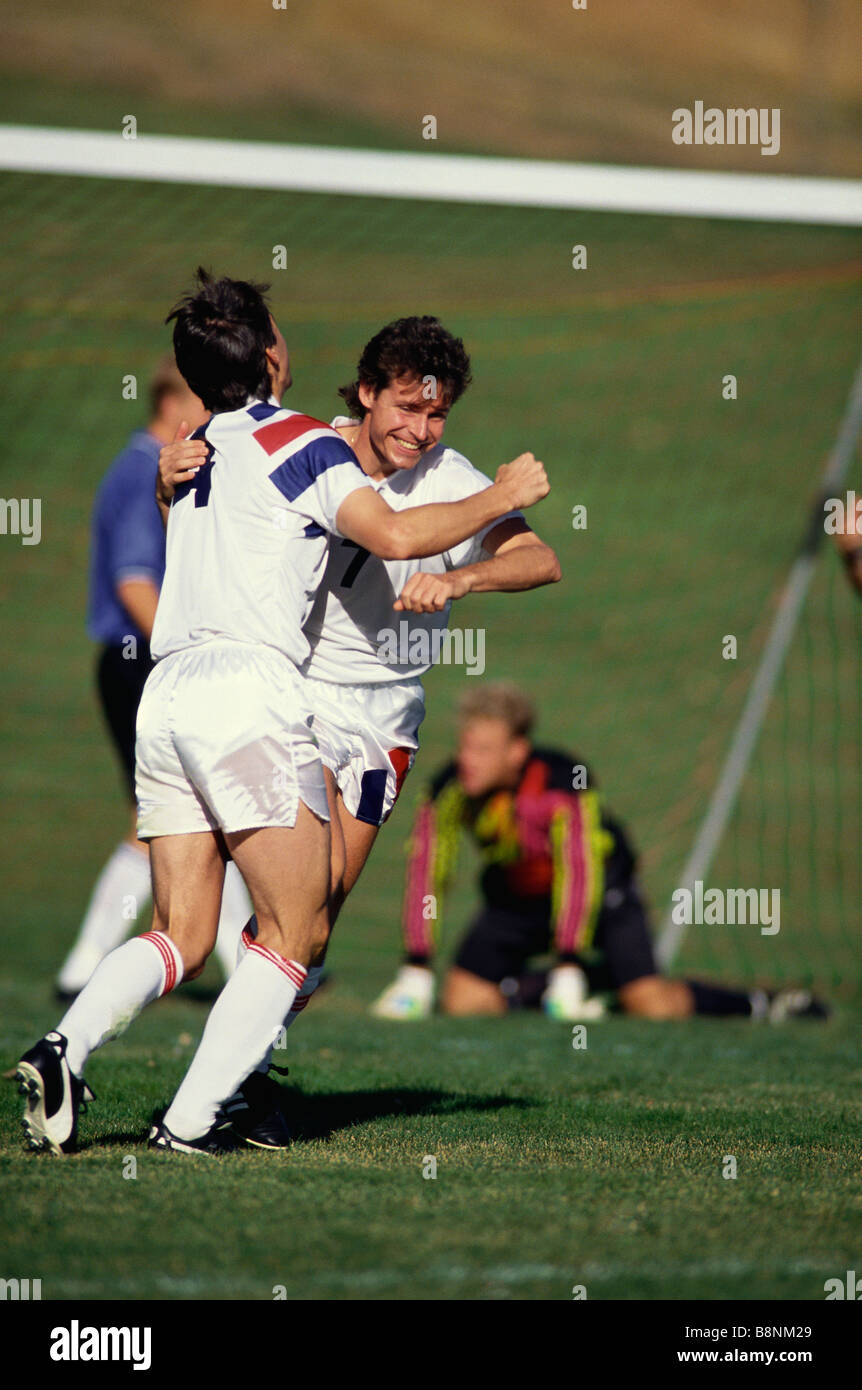 Soccer players celebrating after scoring a goal Stock Photo - Alamy