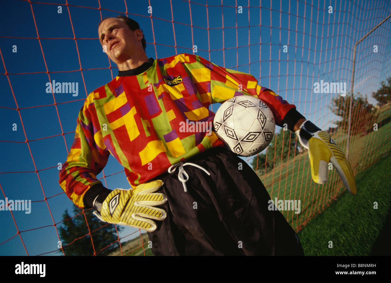 Portrait of soccer goalie in the net Stock Photo - Alamy