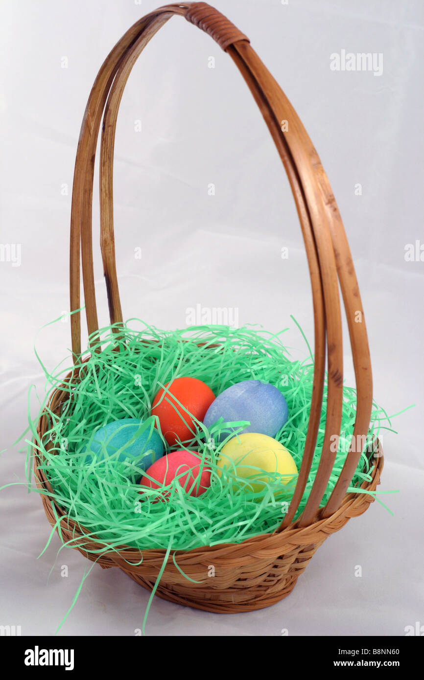 Easter basket filled with colored eggs Stock Photo - Alamy