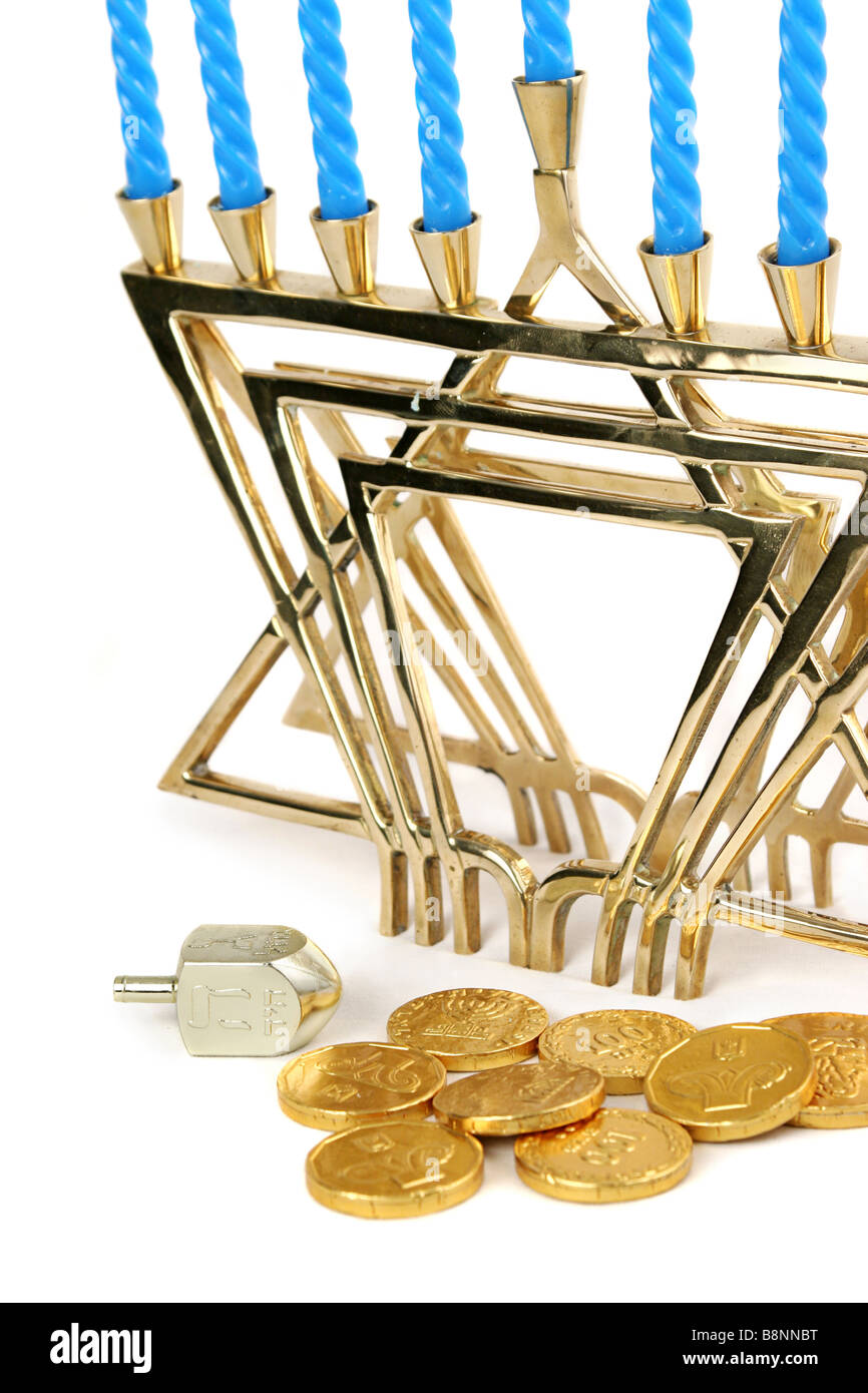 Chanukah menorah with a dreidel and gelt Stock Photo - Alamy