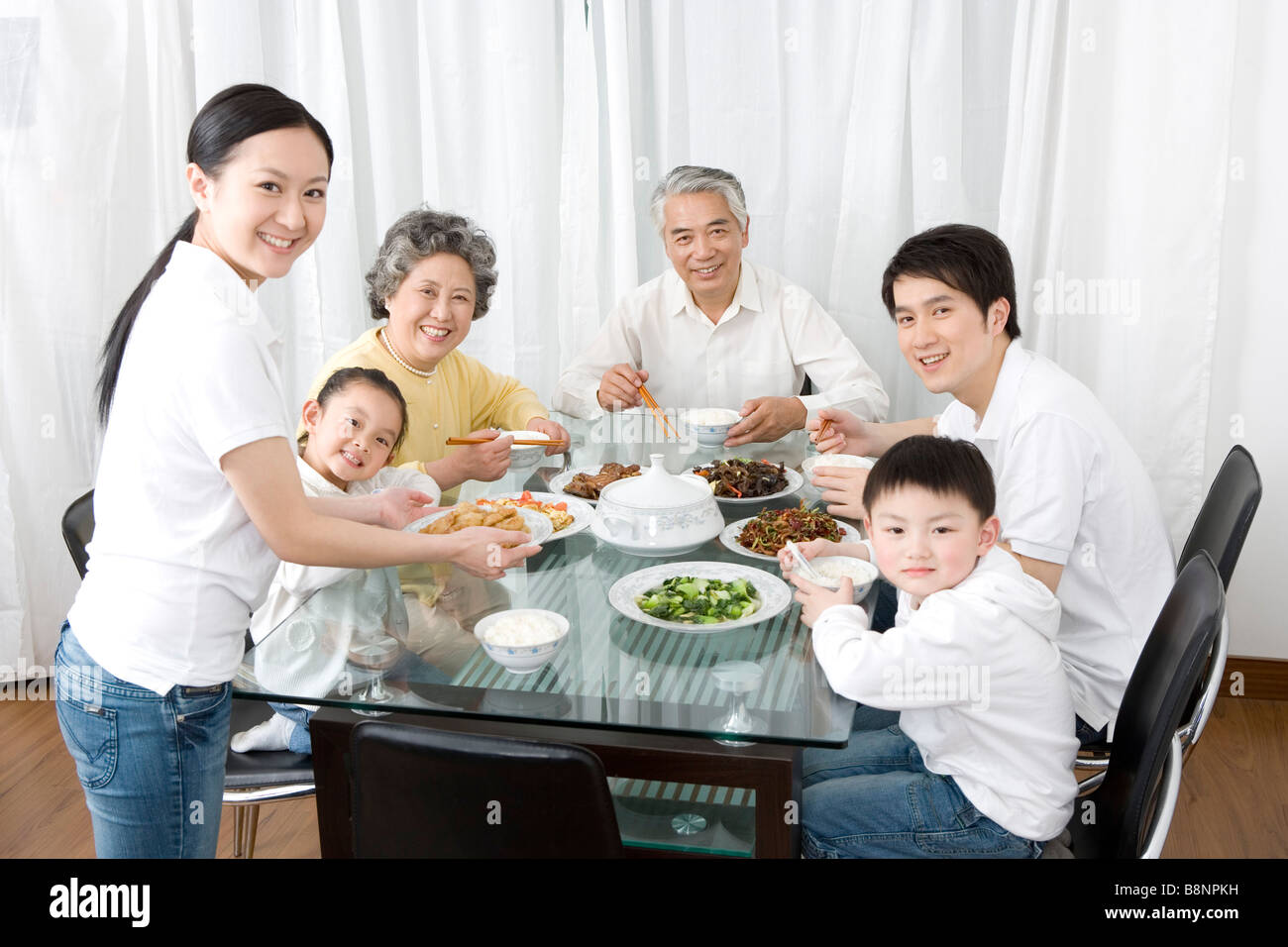 Three generation family eating meal Stock Photo - Alamy