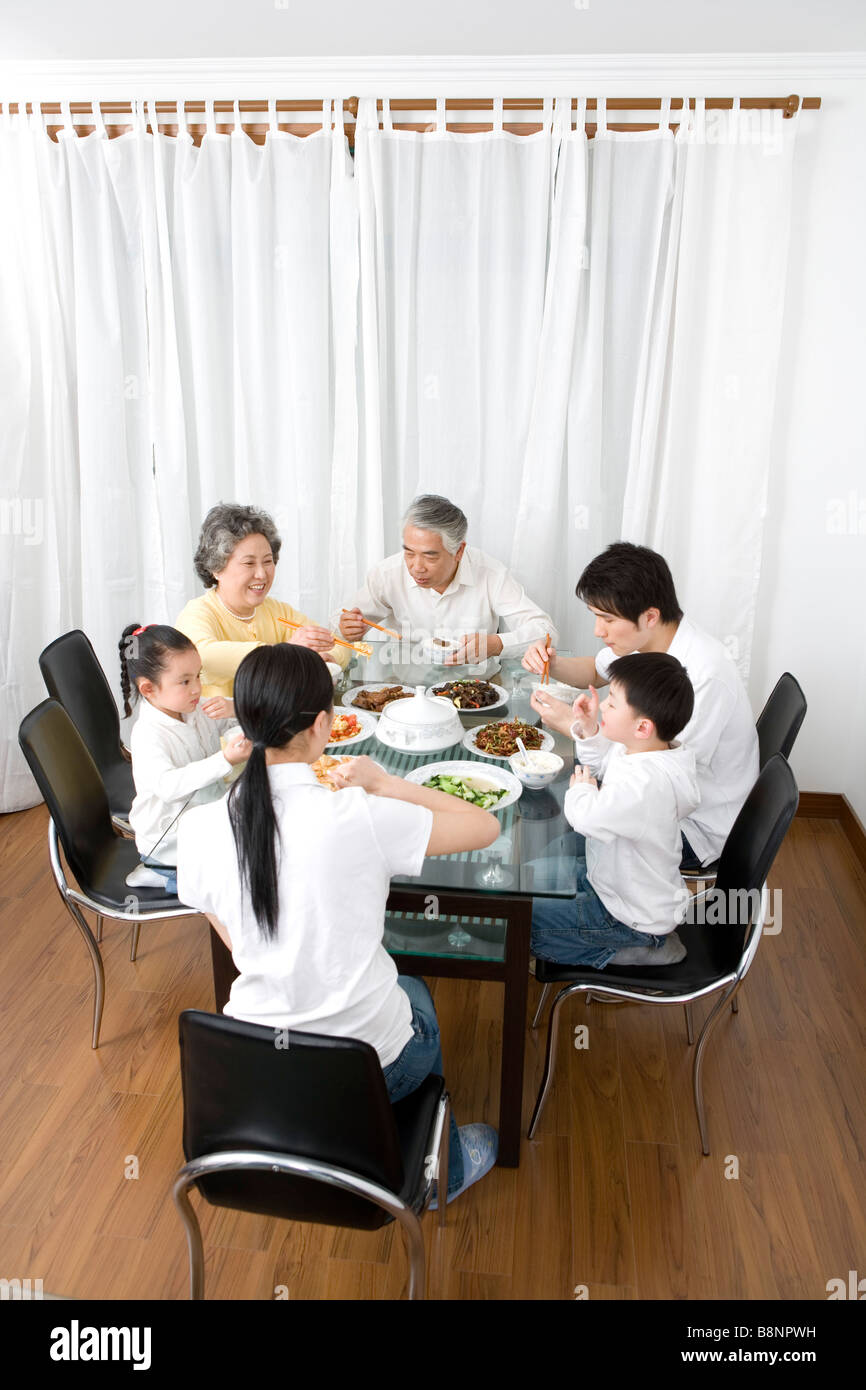 Three generation family eating meal Stock Photo - Alamy