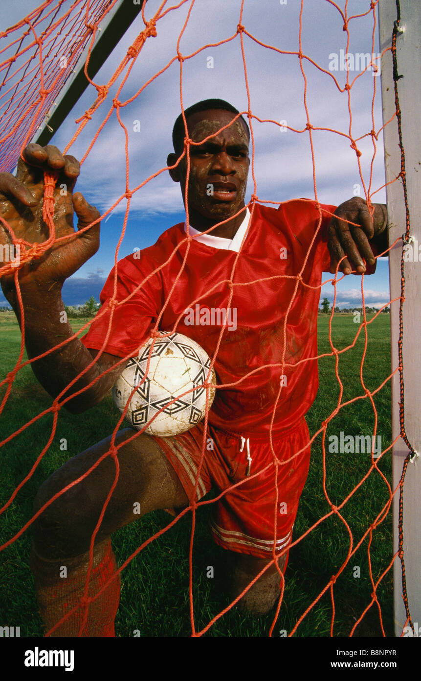 Portrait of soccer goalie in the net Stock Photo - Alamy