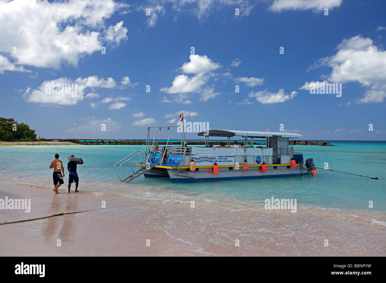 Tourists getting ready for diving at Pebbles Beach, West Coast of ...