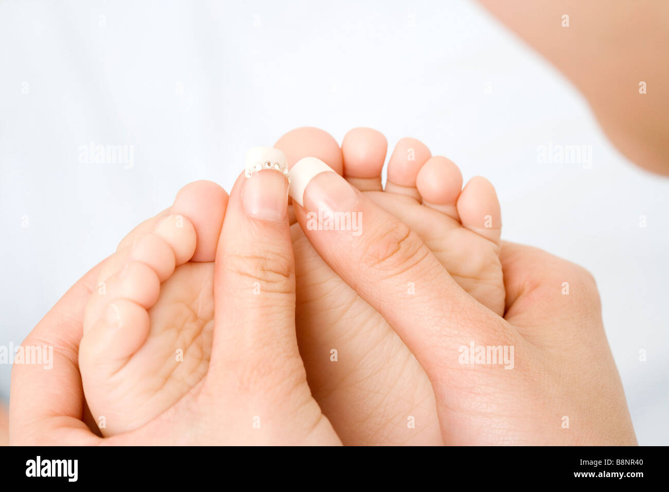 Hands holding little feet Stock Photo - Alamy