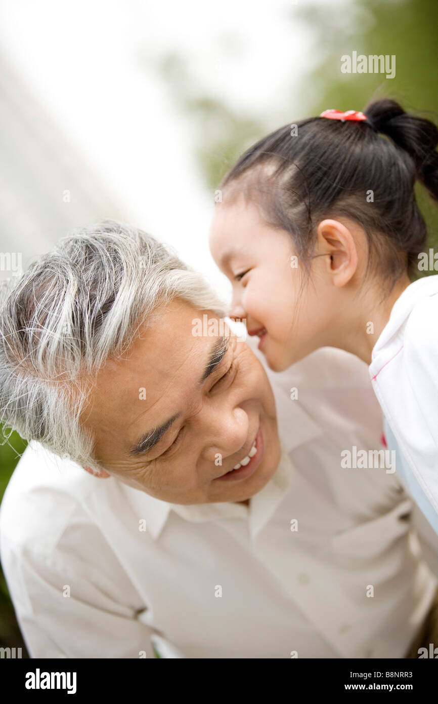 Granddaughter whispering in grandfather s ear Stock Photo - Alamy