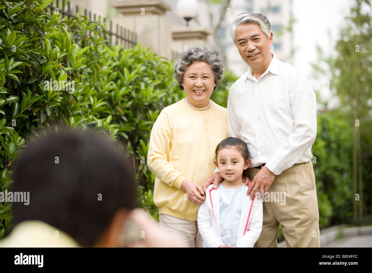 Man taking picture for parents and daughter Stock Photo - Alamy