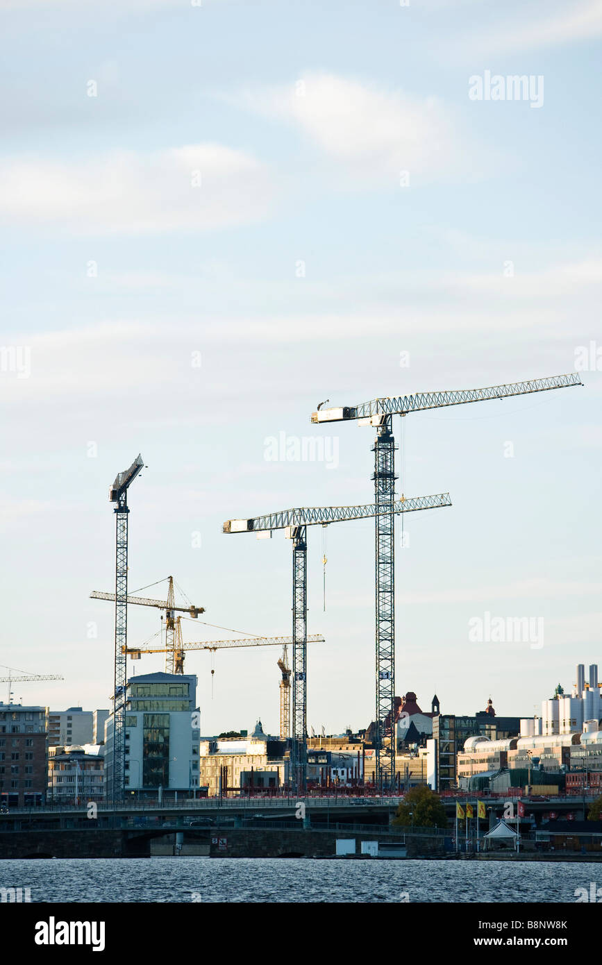 Sweden, Stockholm, construction cranes along water's edge Stock Photo ...
