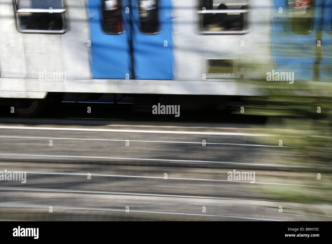 fast metro train on tracks in city Stock Photo - Alamy