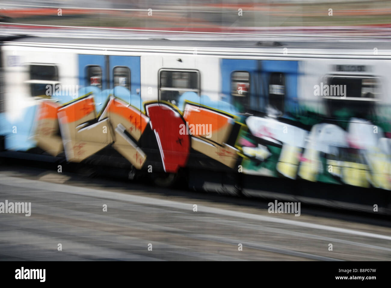 fast metro train covered with graffiti art on tracks in city Stock ...