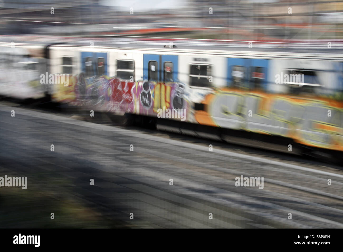 fast metro train covered with graffiti art on tracks in city Stock ...