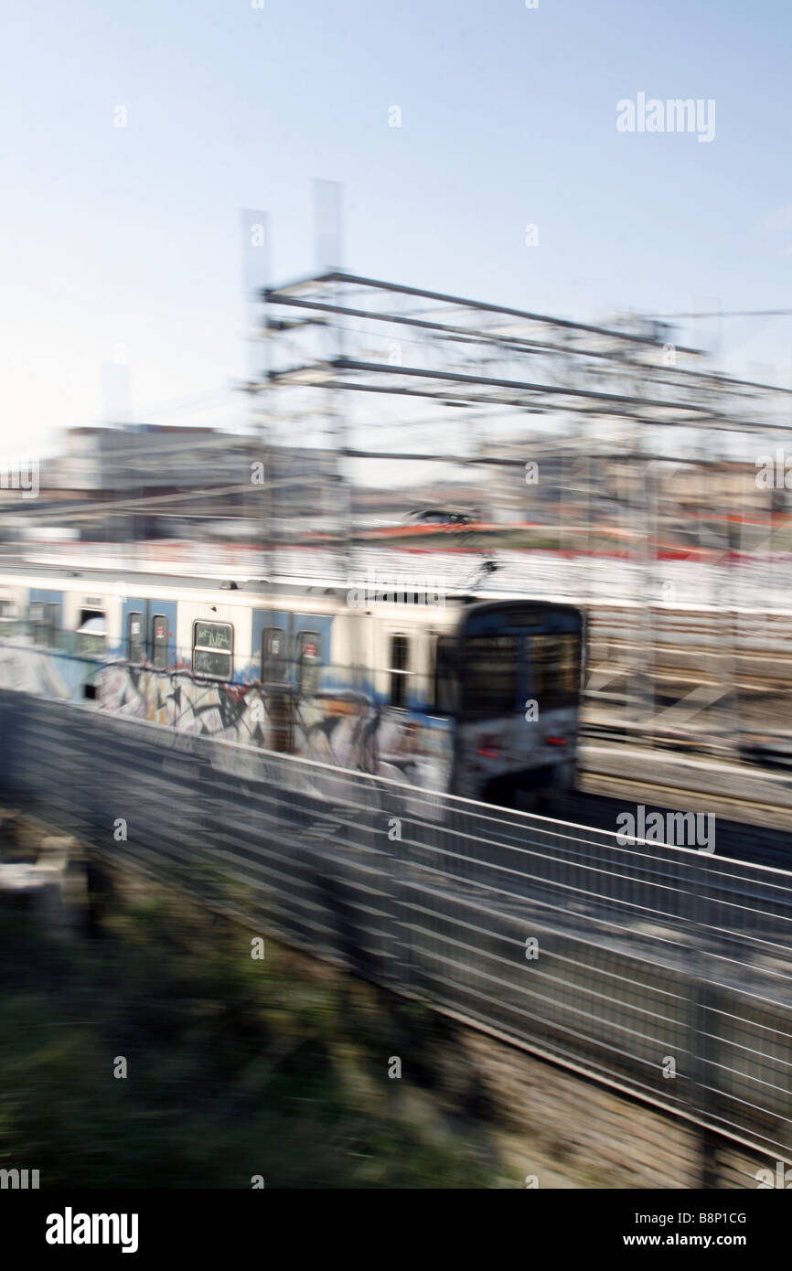fast metro train covered with graffiti art on tracks in city Stock ...