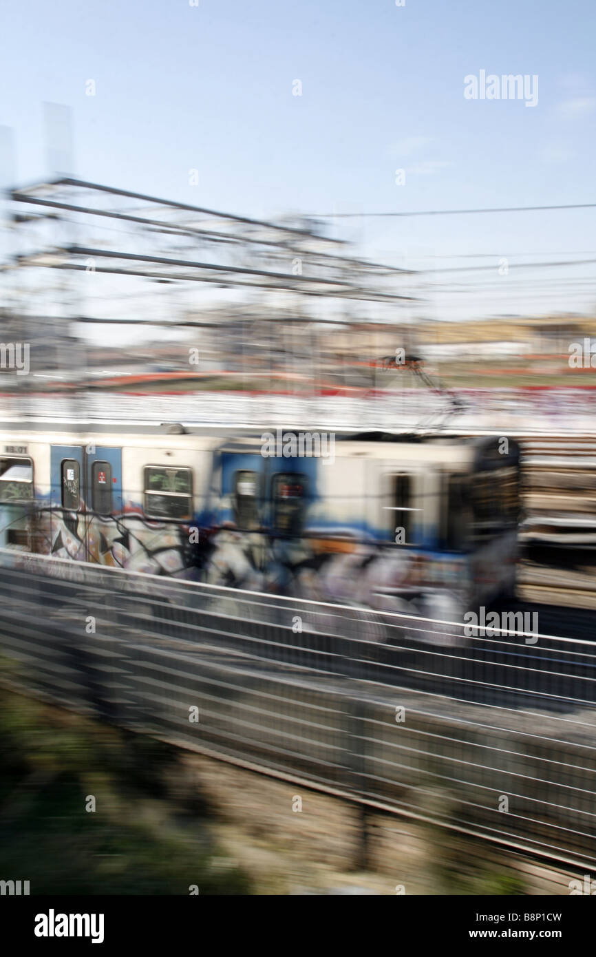 fast metro train covered with graffiti art on tracks in city Stock ...