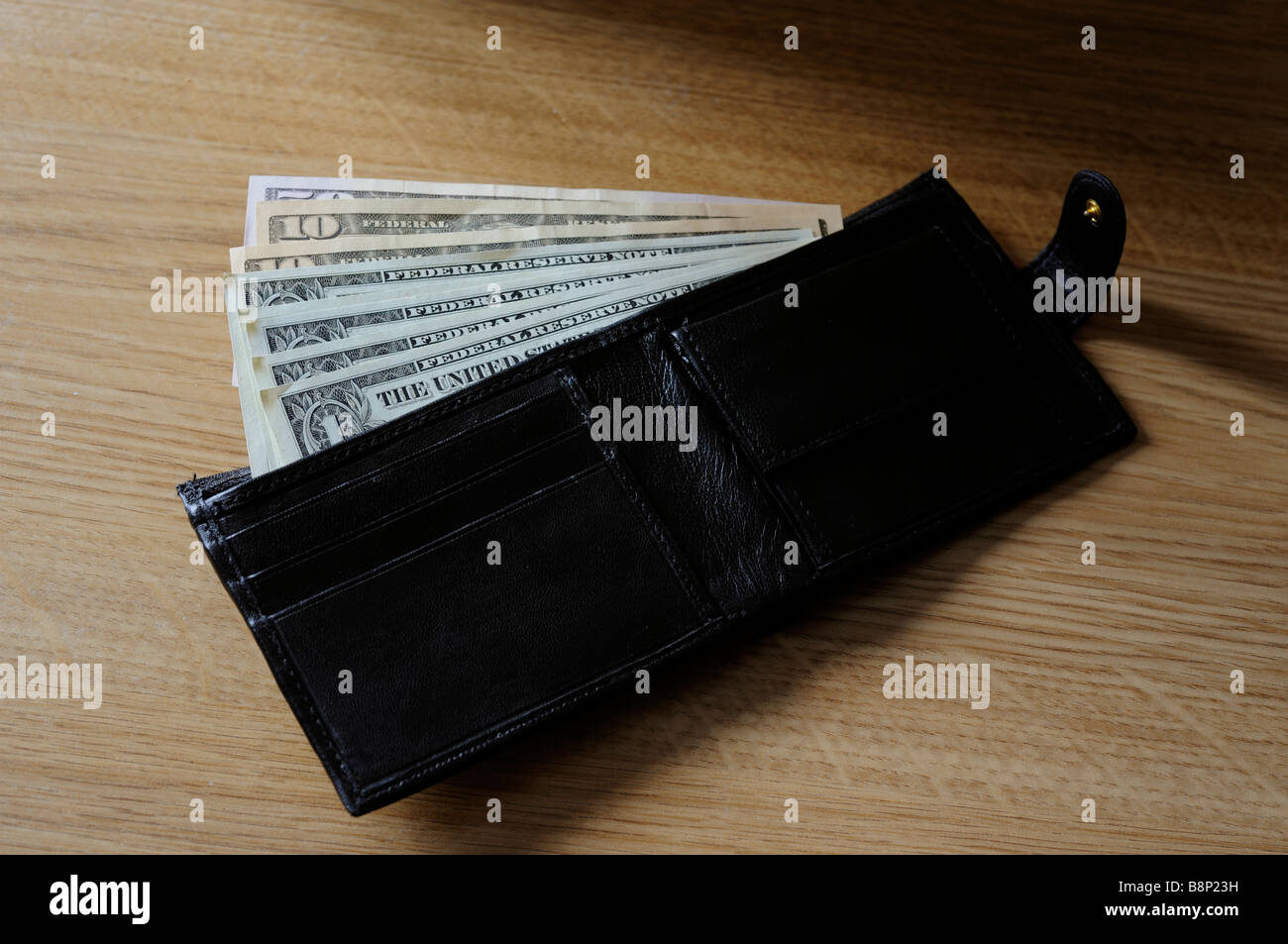 Wallet with dollar bills Stock Photo - Alamy
