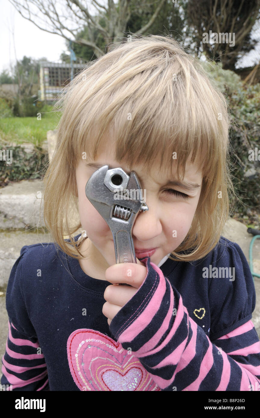 A six year old girl plays with an adjustable spanner Stock Photo - Alamy
