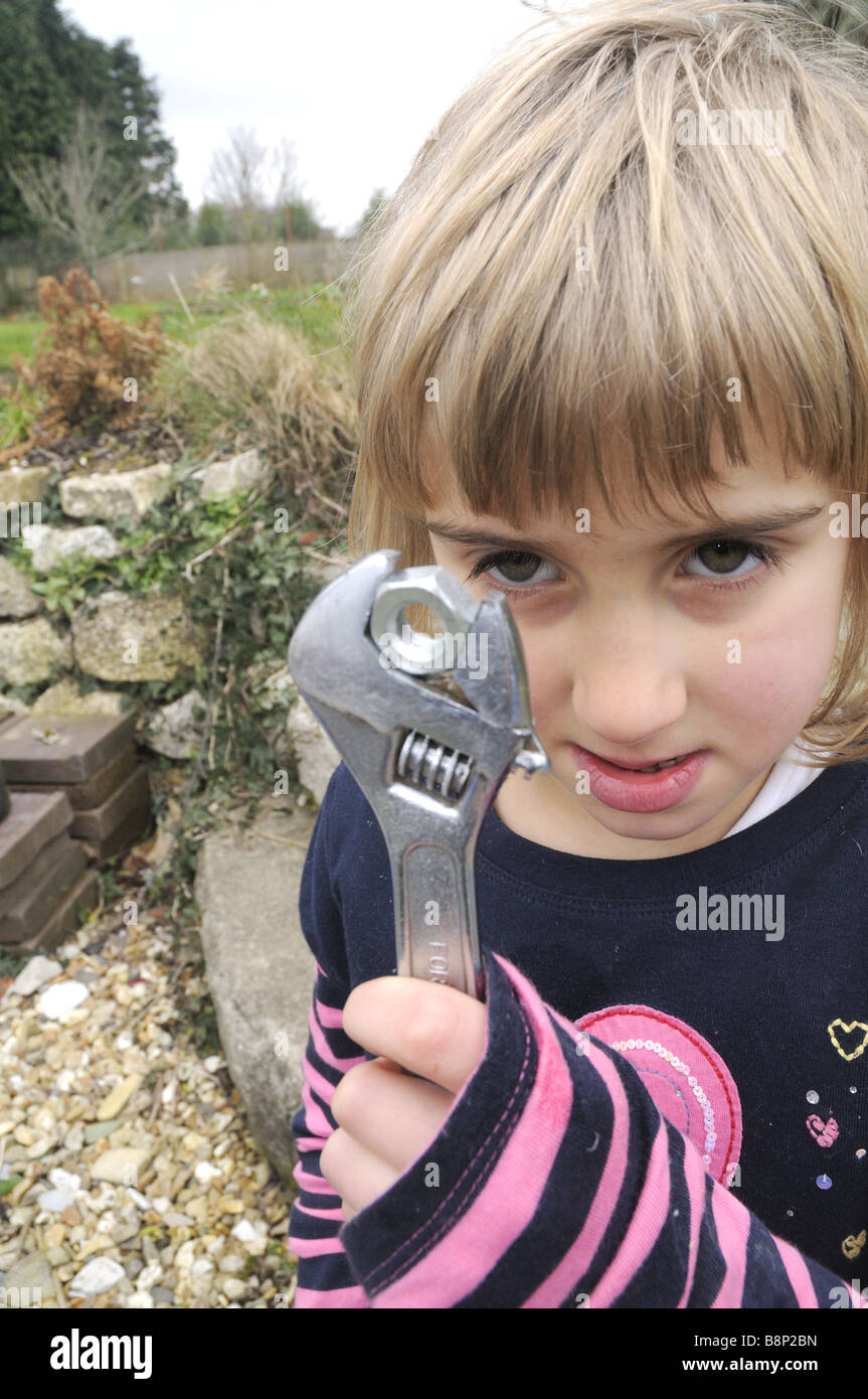 A six year old girl plays with an adjustable spanner Stock Photo - Alamy