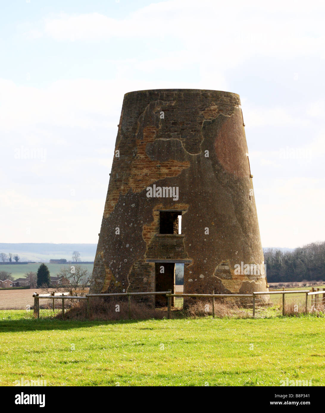 A ruined, abandoned windmill tower on a hillside Stock Photo - Alamy