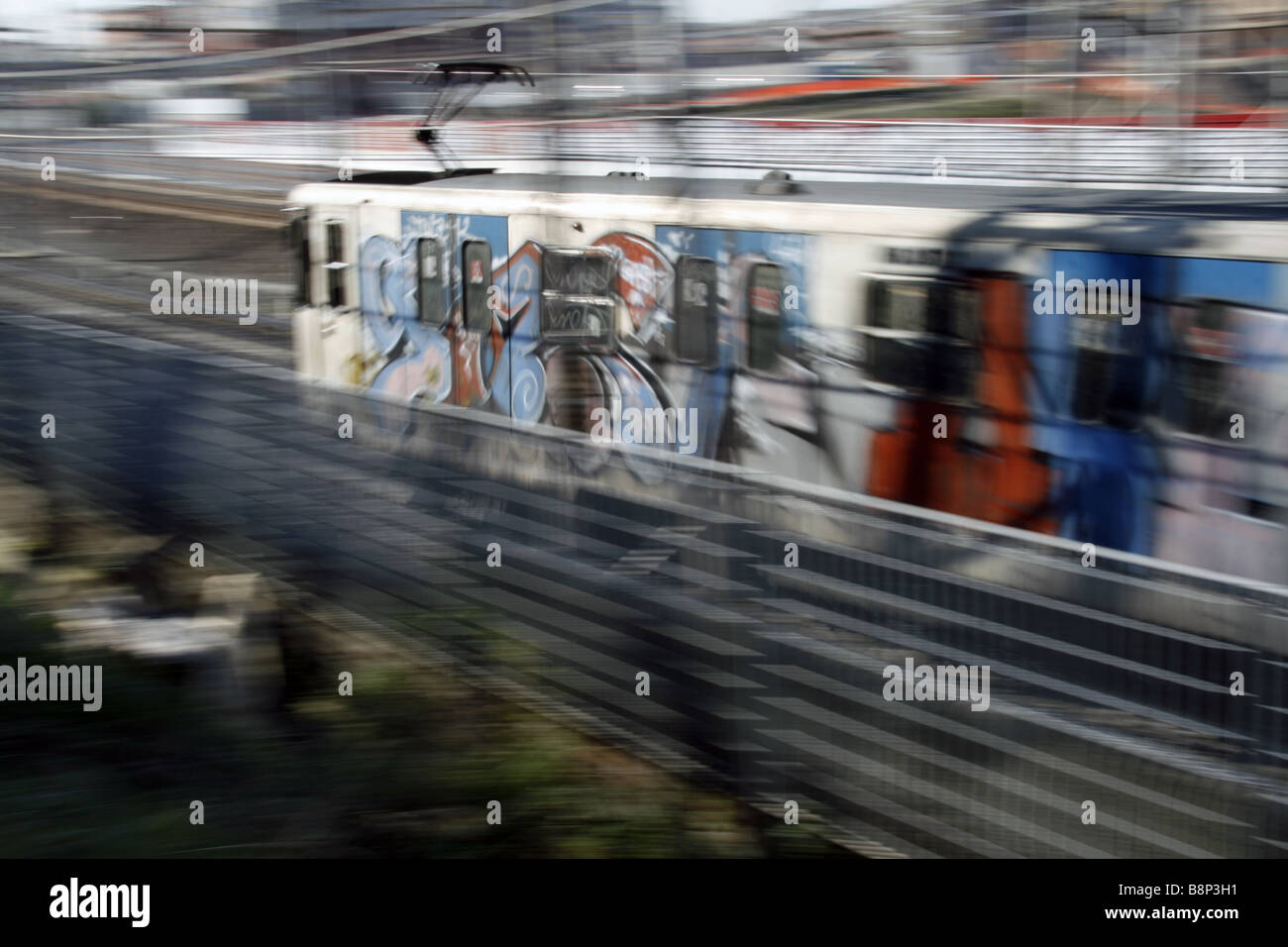 fast metro train covered with graffiti art on tracks in city Stock ...