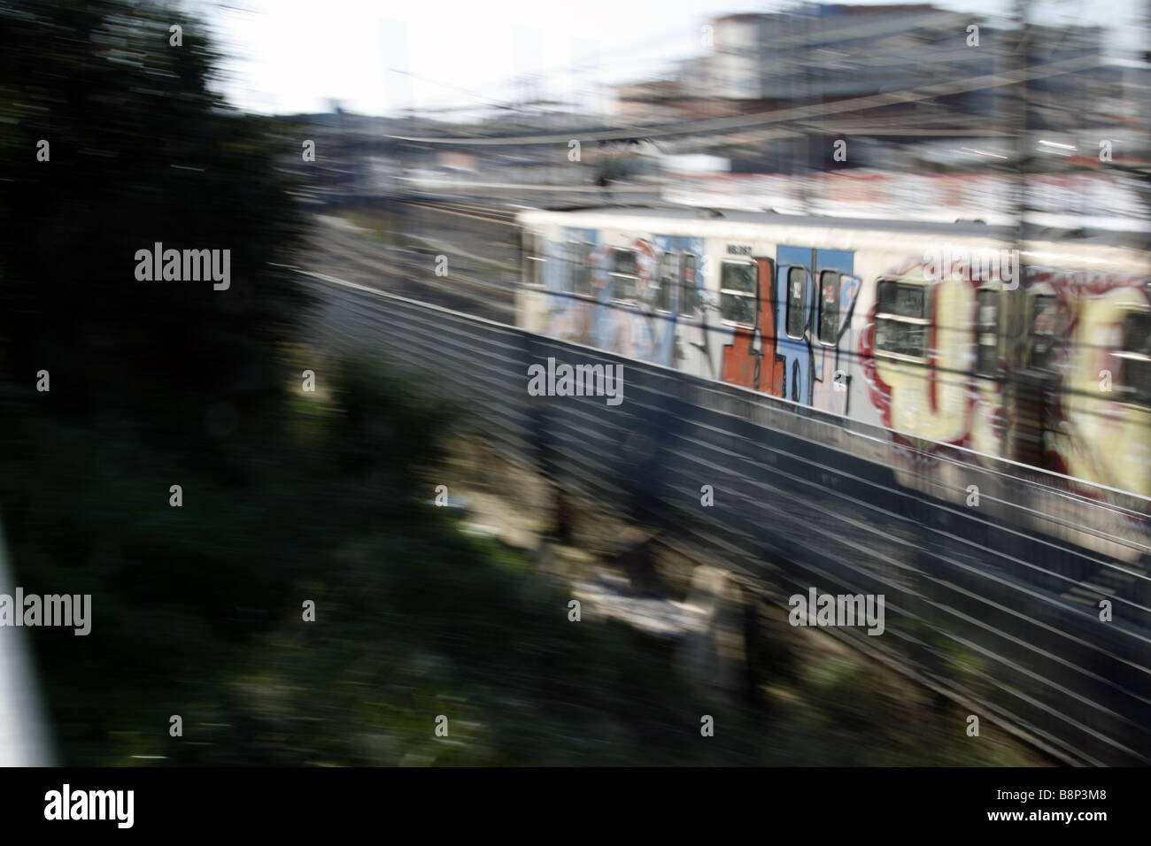 fast metro train covered with graffiti art on tracks in city Stock ...